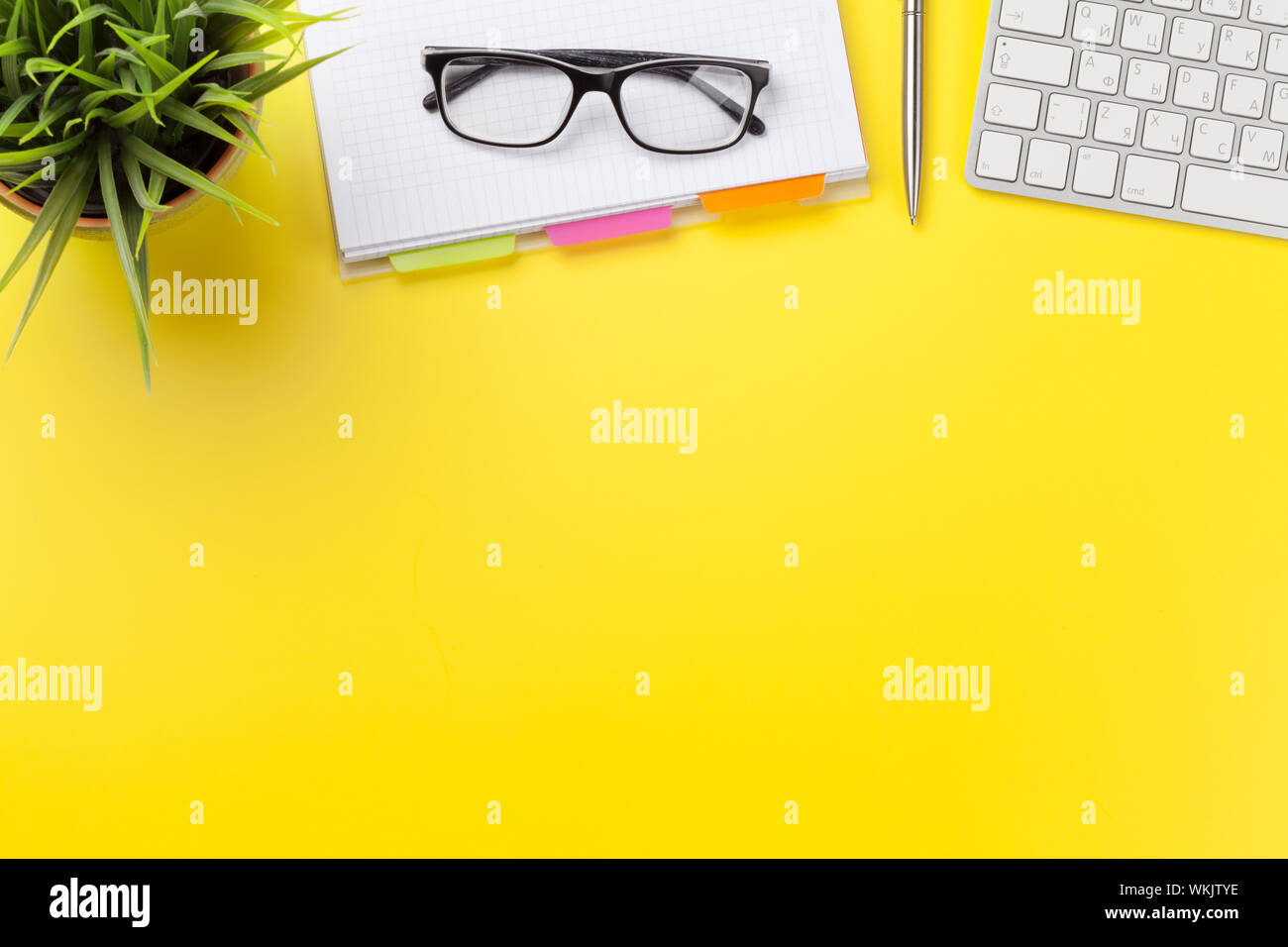 Office yellow workplace backdrop with supplies and computer. Flat lay ...