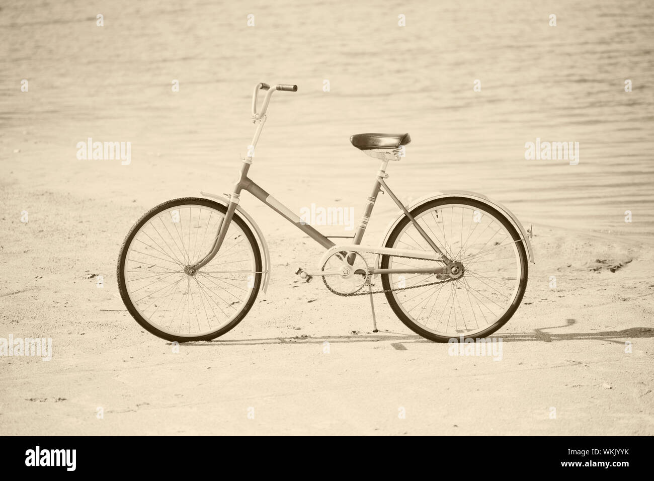 Ancient bicycle photographed on a summer beach - retro sepia Stock ...