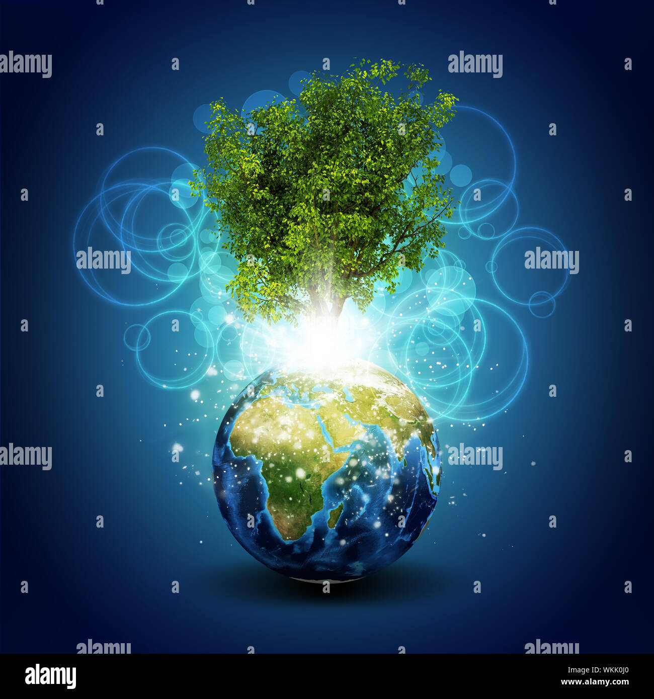 Earth with magical green tree and rays of light on dark background ...
