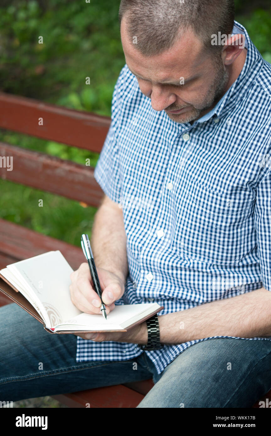 Young man write book outdoor hi-res stock photography and images - Alamy