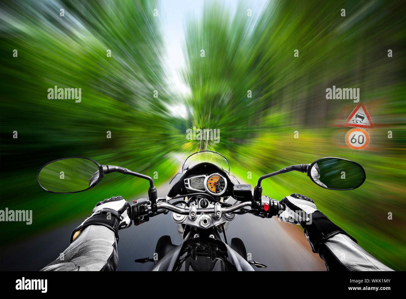Motorcycle drives through the forest with excessive speed Stock Photo ...