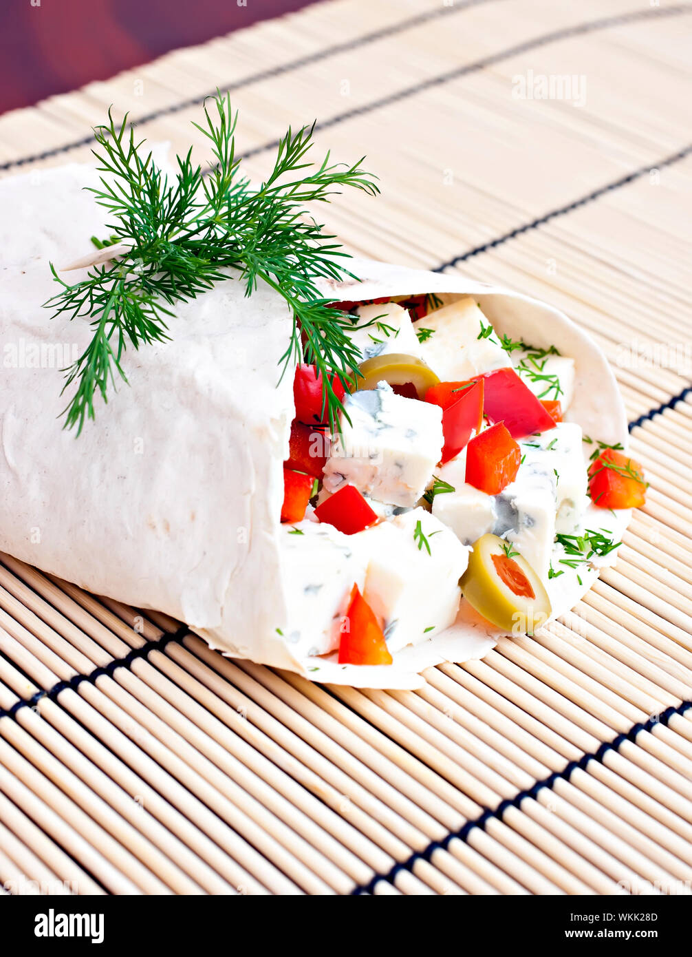 Lavash with a cheese filling, tomato, peppers, olives and fennel Stock ...