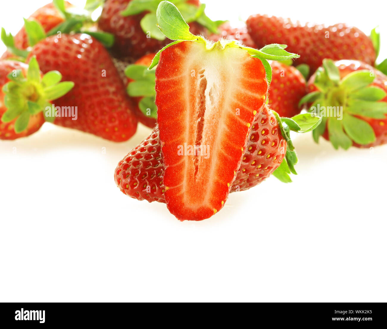 one cut fresh ripe strawberry and few as background with copy space ...