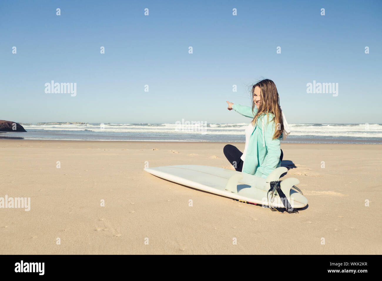 Teenager sitting pointing back hi-res stock photography and images - Alamy