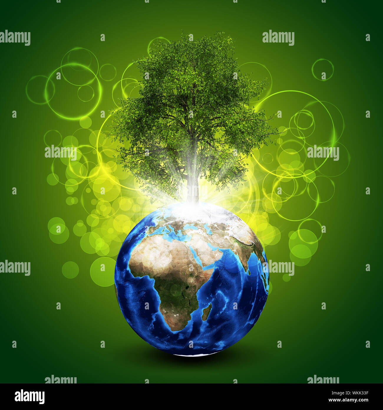 Earth with magical green tree and rays of light on dark background ...