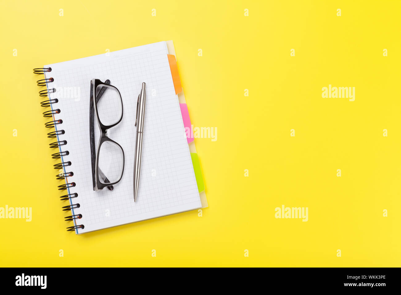 Office yellow workplace backdrop with supplies. Flat lay. Top view with ...