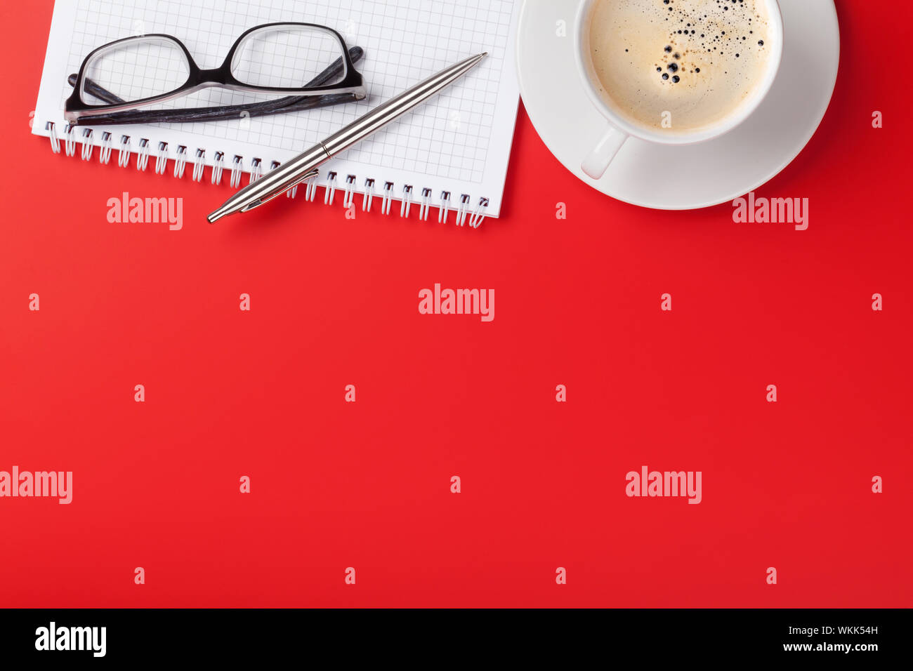 Office red workplace backdrop with coffee cup and supplies. Flat lay ...