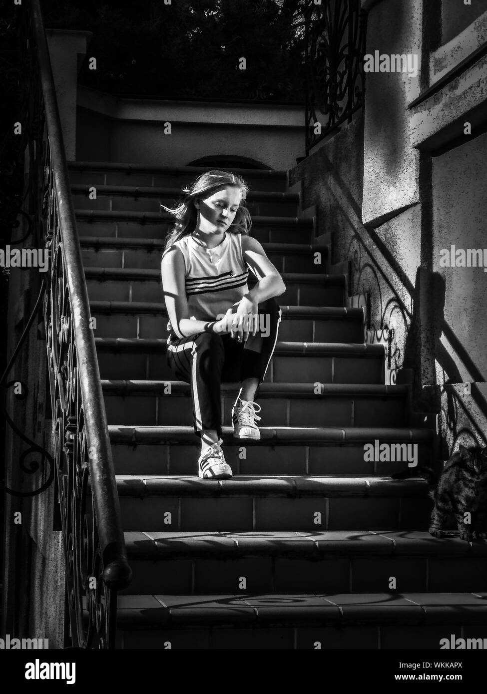 Girl sitting on steps Black and White Stock Photos & Images - Alamy