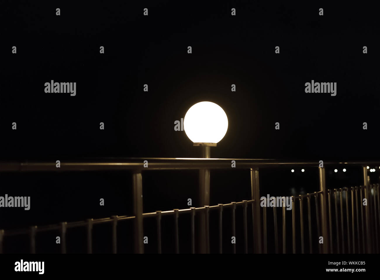 Sphere glow lantern with railings. Night background Stock Photo - Alamy