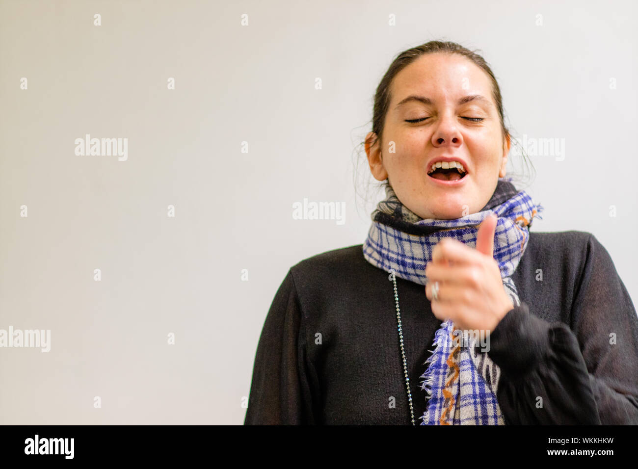 Woman Making Face Against Wall Stock Photo - Alamy