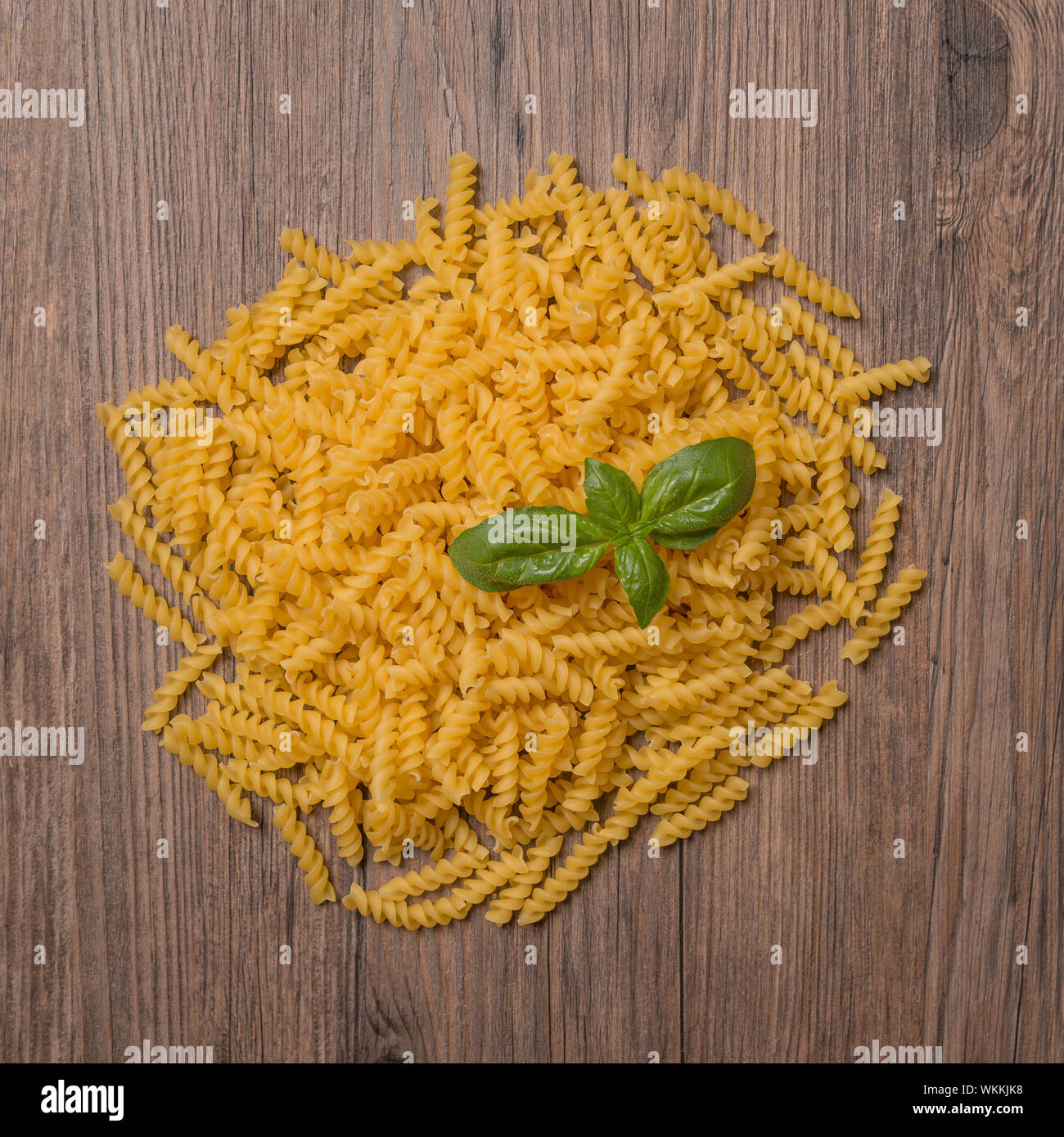 Uncooked italian pasta, brown wood table background Stock Photo - Alamy
