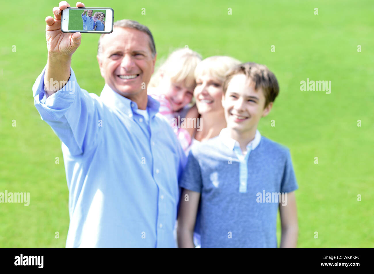 Happy family capturing memorable moment Stock Photo - Alamy