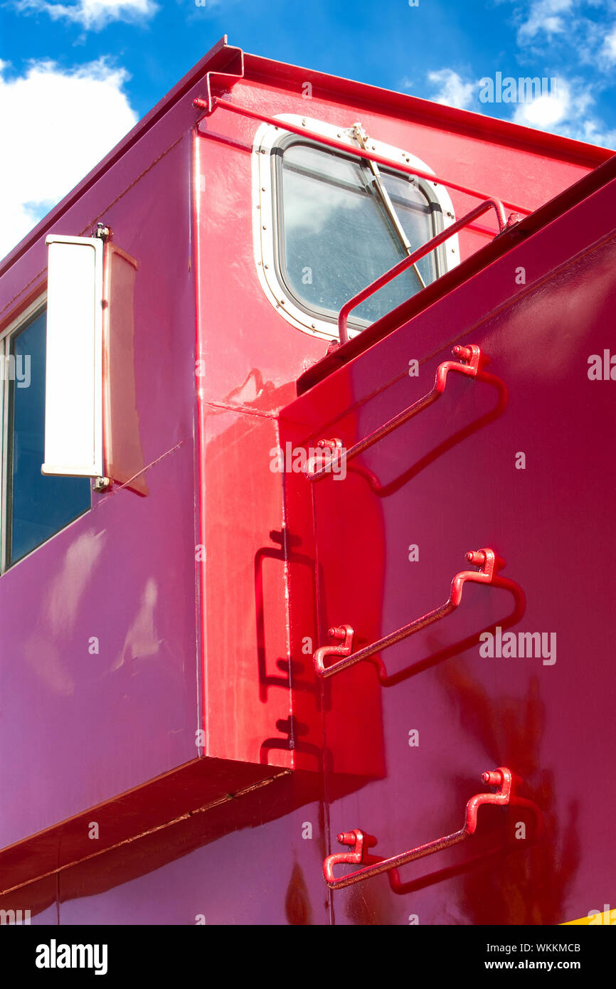 Detail of red train caboose against blue sky Stock Photo - Alamy