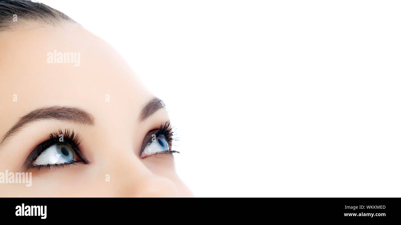 Young female looking at something above, white background Stock Photo ...