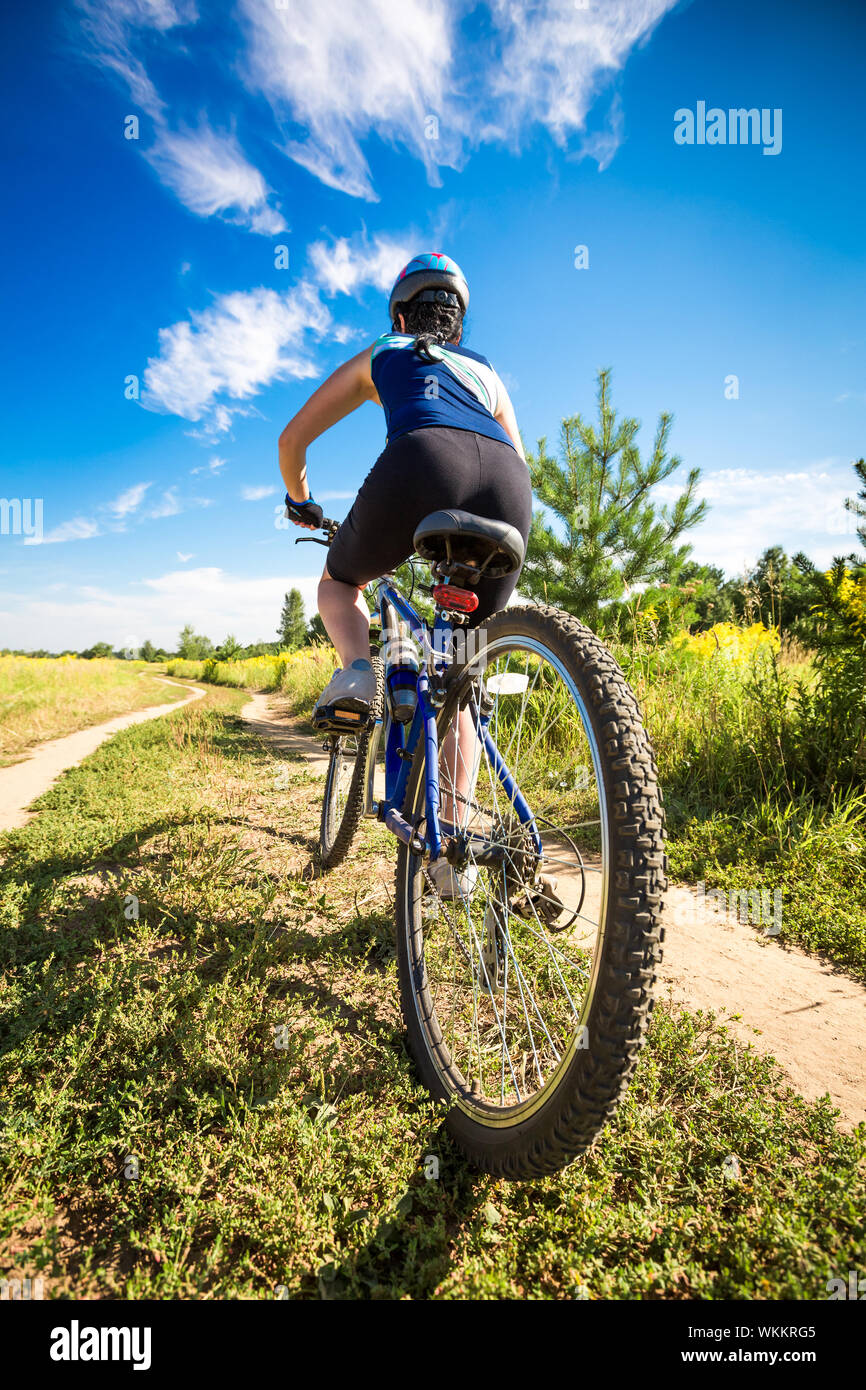 Women on the nature of riding a bike Stock Photo - Alamy