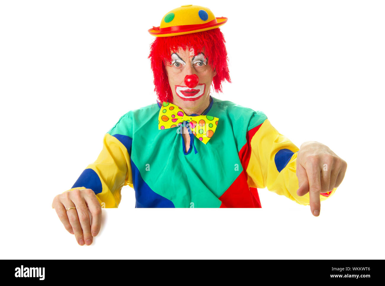 Clown with a white card pointing to youre text Stock Photo - Alamy