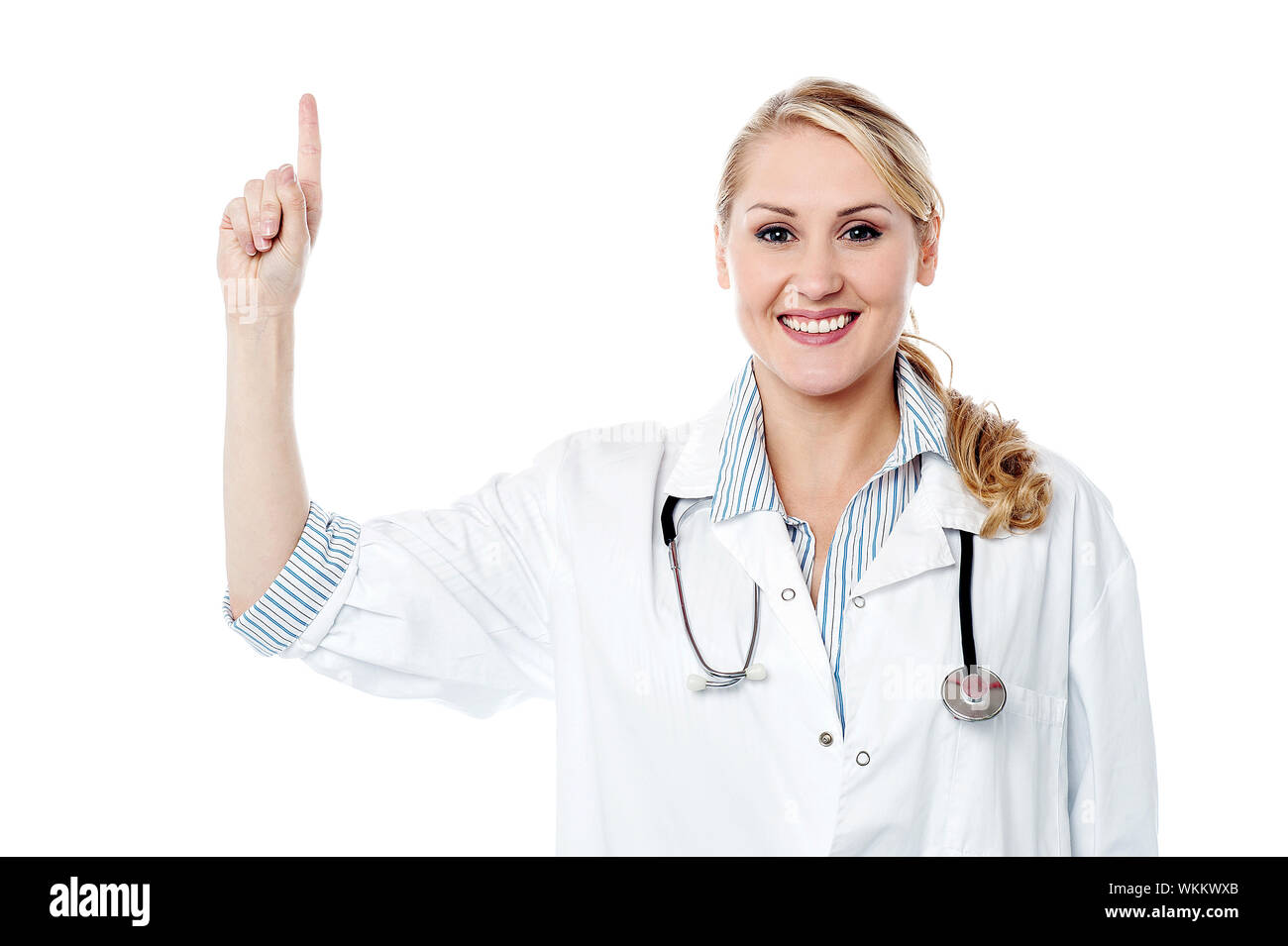 Attractive female doctor pointing finger upwards Stock Photo - Alamy