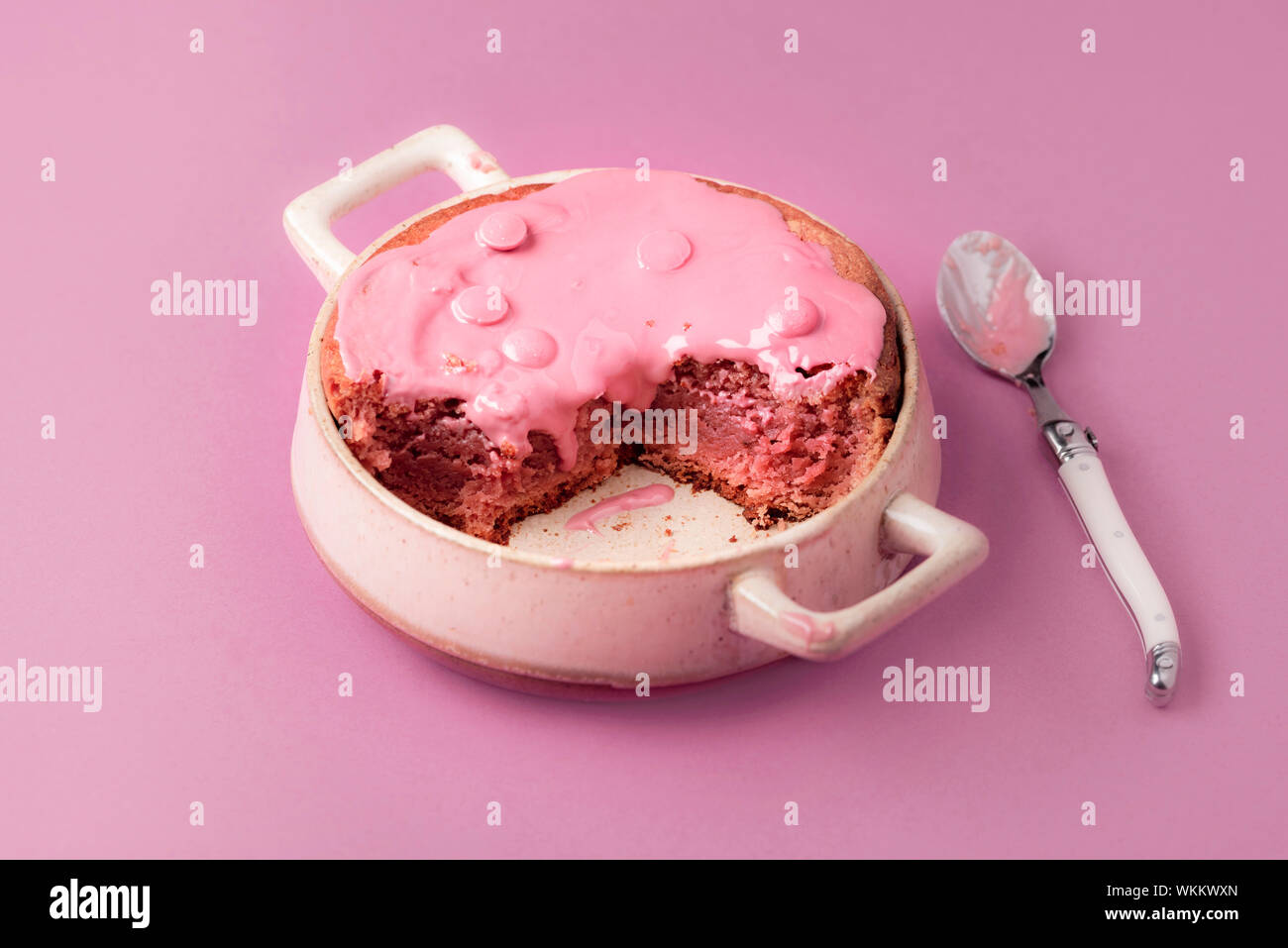 Pink brownie cake eaten from a clay pot with melted ruby chocolate ...