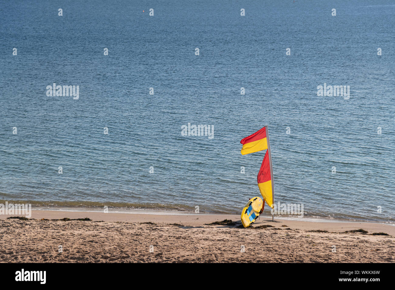 Beach safety flags and surfboard on a Beach in Scotland Stock Photo - Alamy