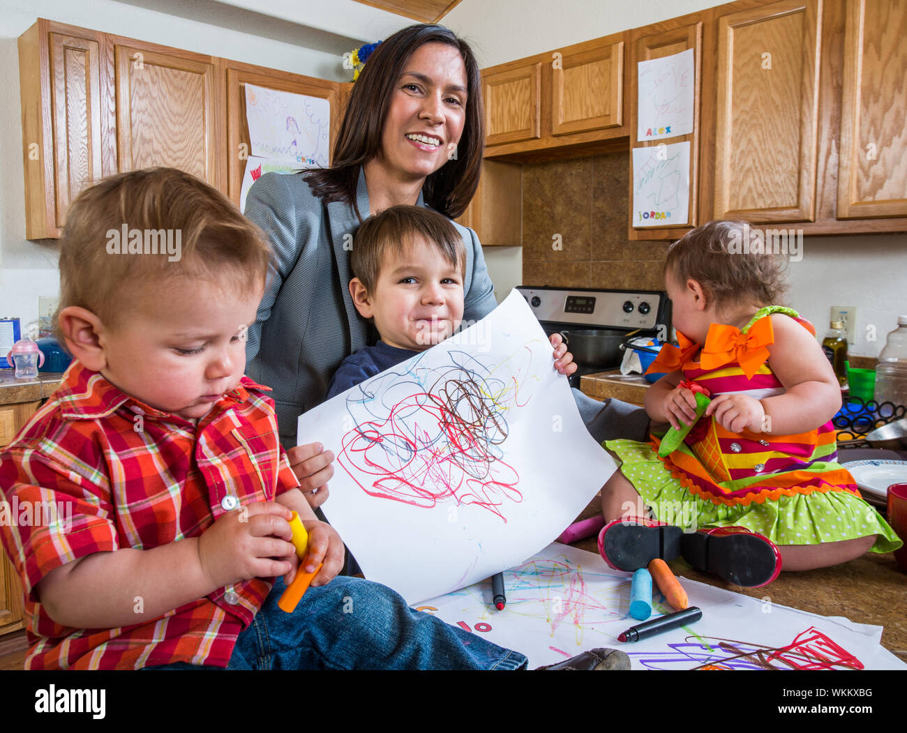 Mother and child in kitchen pose with a drawing Stock Photo - Alamy