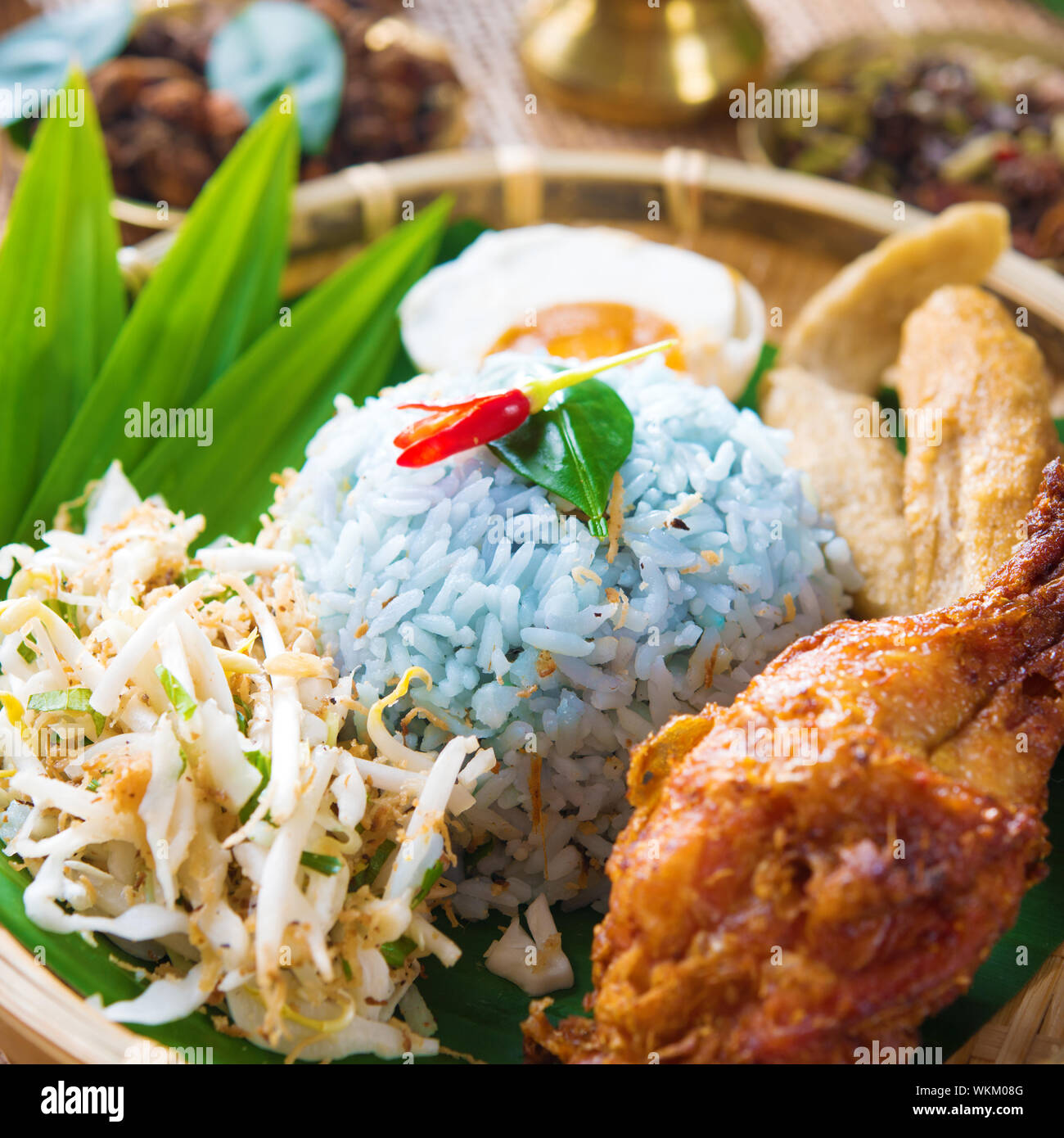 Nasi kerabu or nasi ulam, popular Malay rice dish. Blue color of rice ...