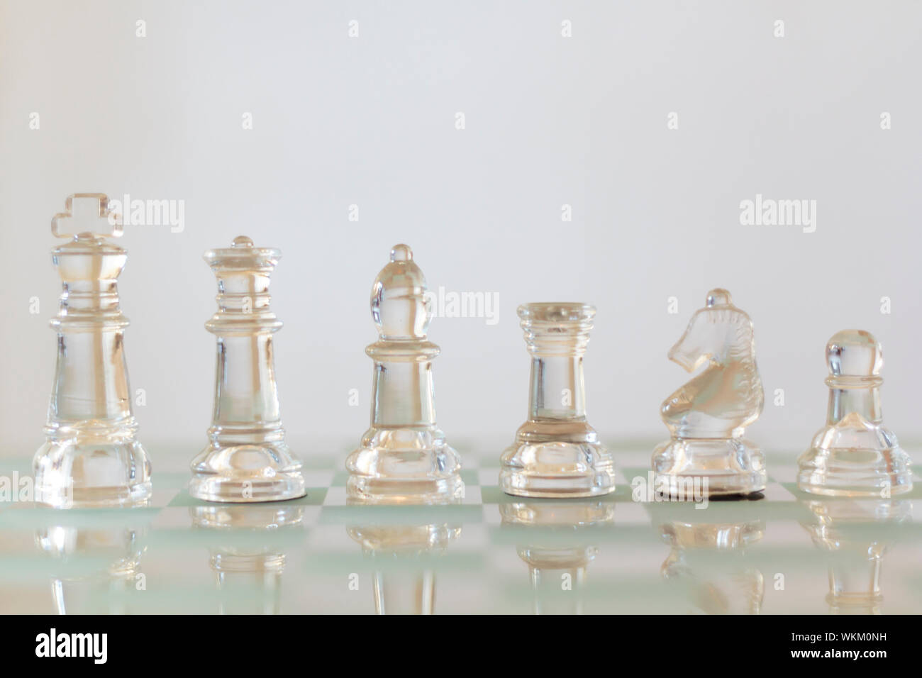 Set of chess pieces standing in line on chessboard Stock Photo - Alamy