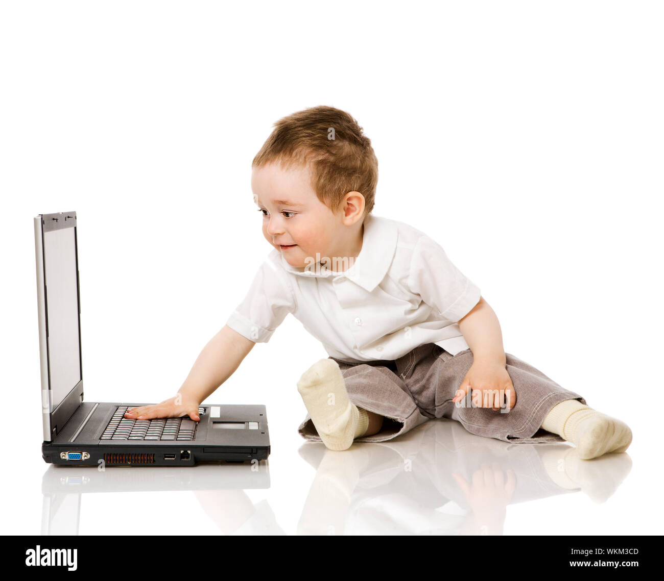 Boy typing on laptop and laughing isolated on white Stock Photo - Alamy