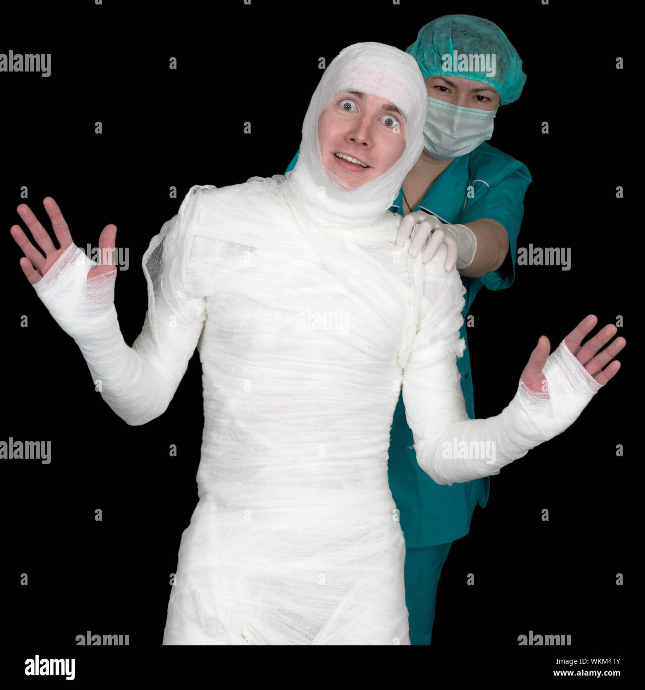Funny sick in bandage and nurse isolated on black background Stock ...