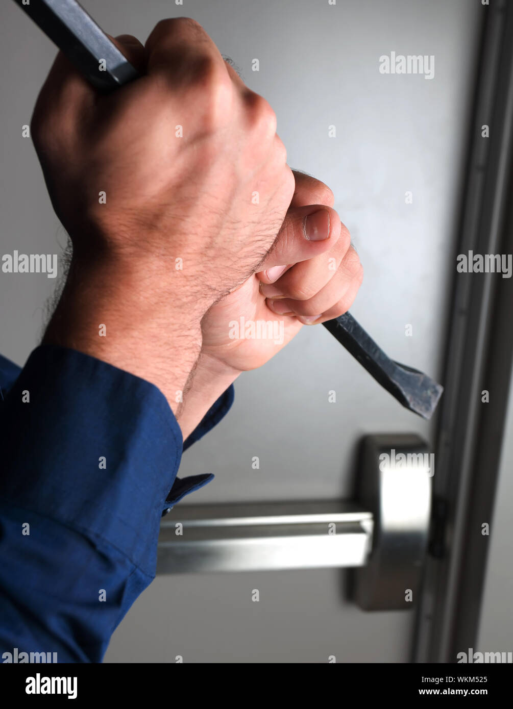 Burglar breaking into a building using crowbar Stock Photo - Alamy