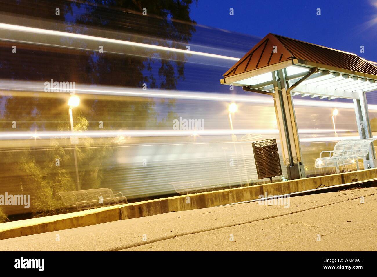 Light Trail On Railroad Station At Night Stock Photo - Alamy
