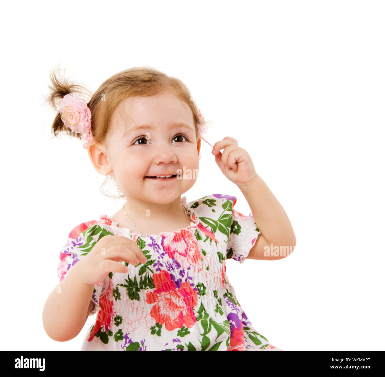 Happy little girl smiling looking up isolated Stock Photo - Alamy