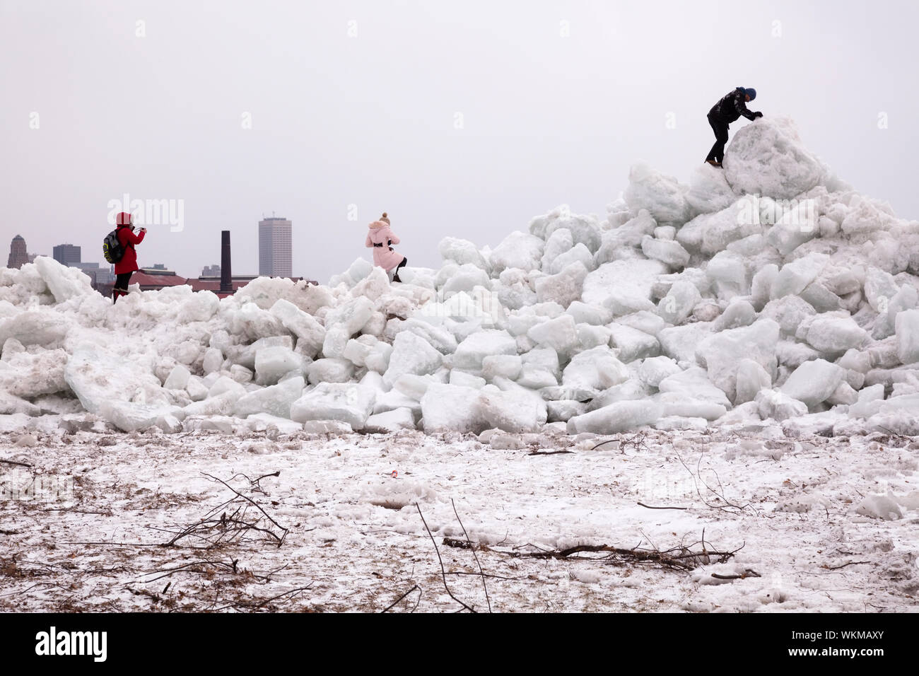 People climbing on top of an ice shove where Lake Erie meets the ...