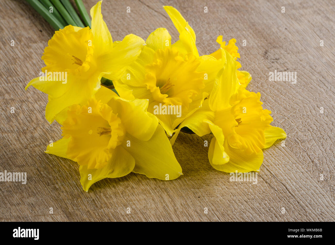 Yellow jonquil flowers on wooden background Stock Photo - Alamy