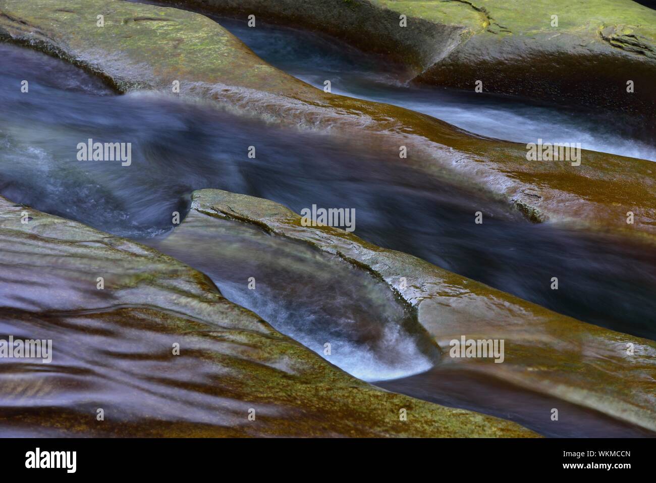 Rock gullies formed by water in the riverbed hi-res stock photography ...