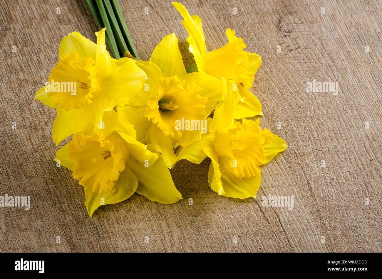 Yellow jonquil flowers on wooden background Stock Photo - Alamy