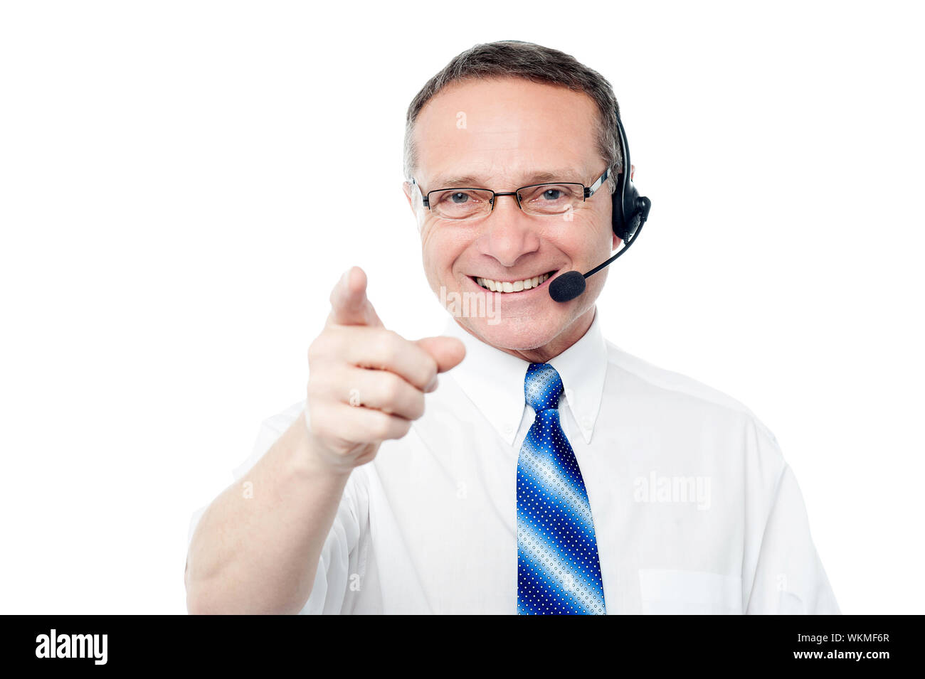 Senior customer support executive pointing to camera Stock Photo - Alamy