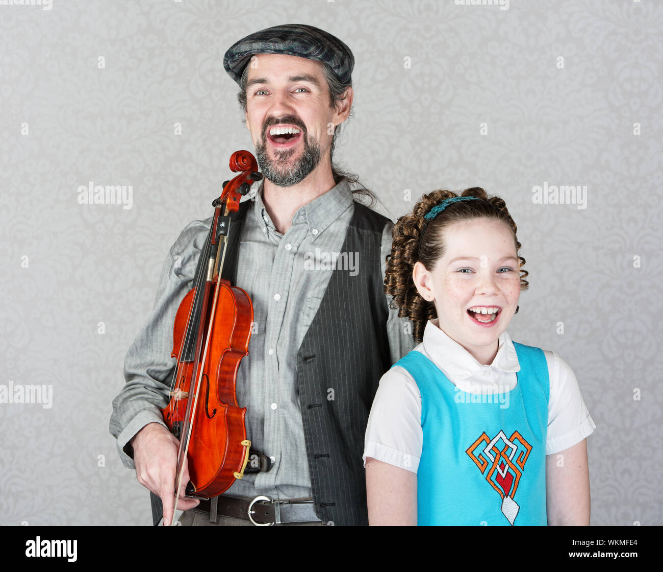 Laughing Irish folk fiddle player with happy child Stock Photo - Alamy