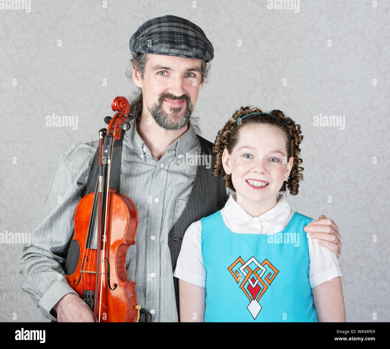 Irish folk fiddler in beard holding violin with child Stock Photo - Alamy