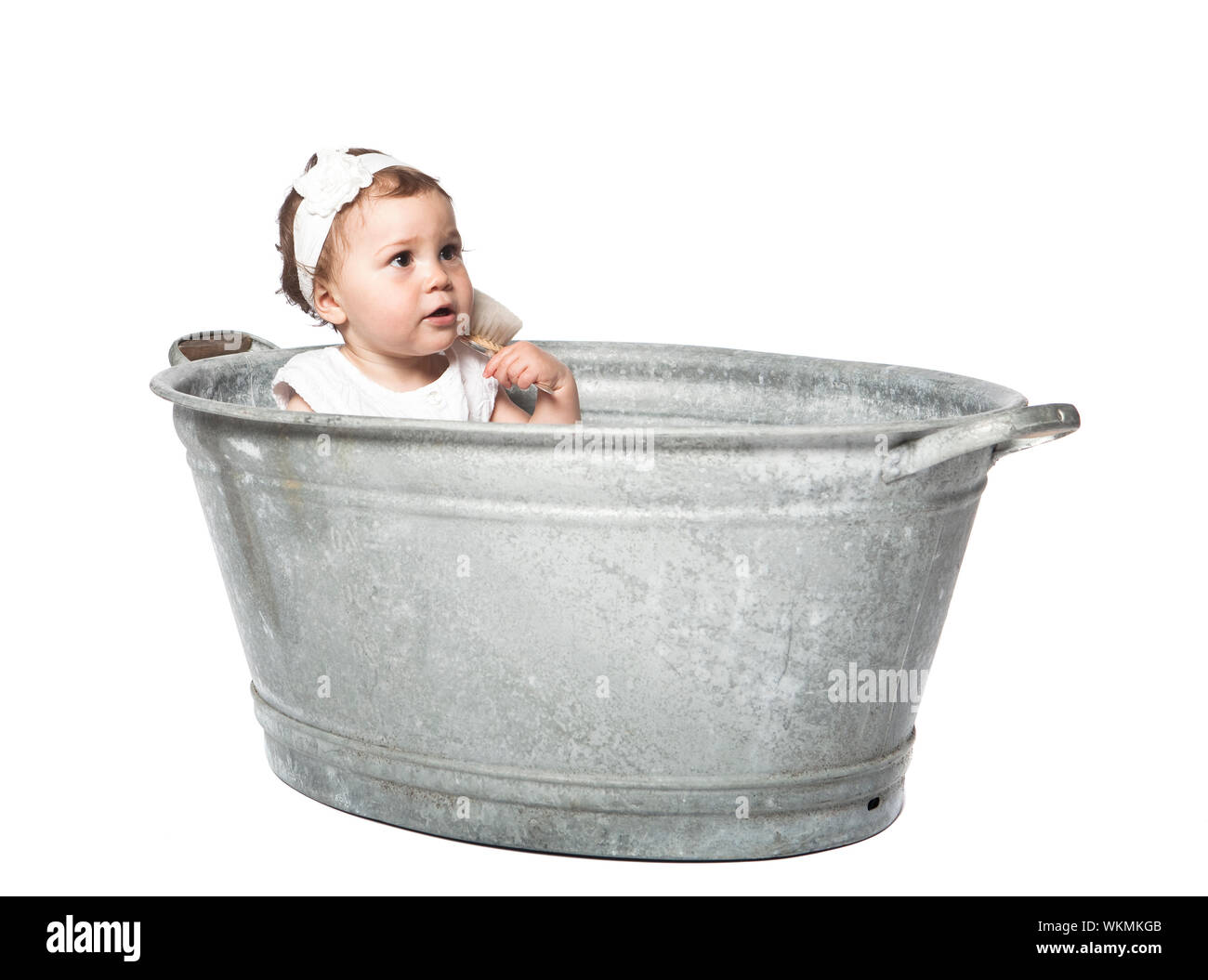 Baby in a bucket isolated on white Stock Photo - Alamy