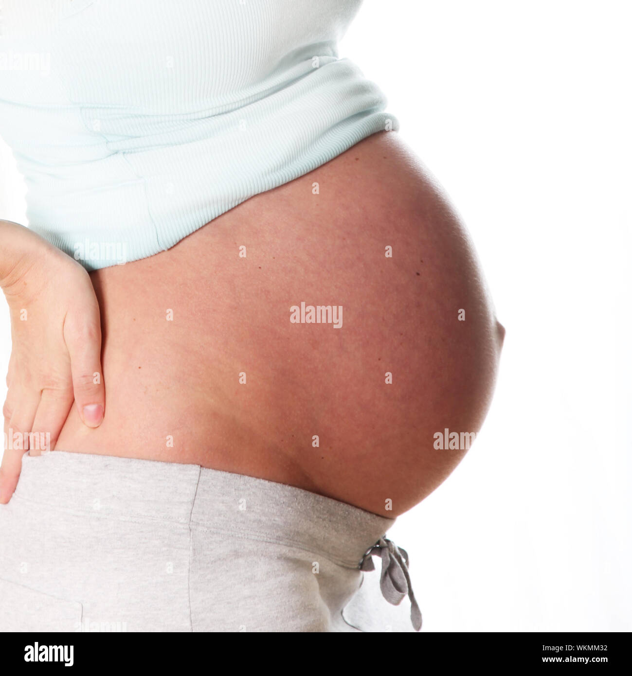 Baby in belly of pregnancy. Only the stomach can be seen from the side ...
