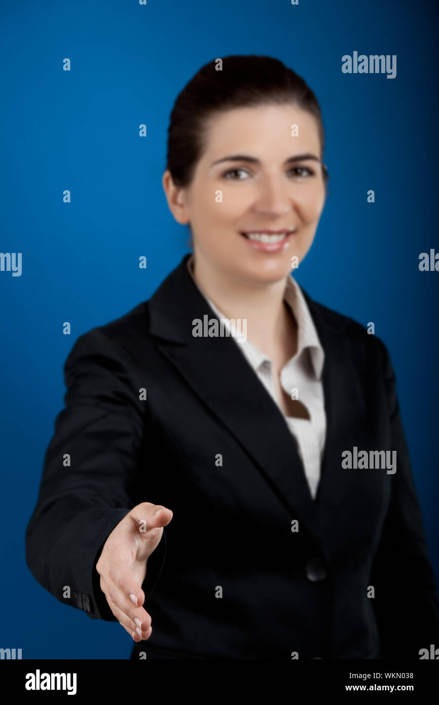 Beautiful and young businesswoman giving a shake hand Stock Photo - Alamy