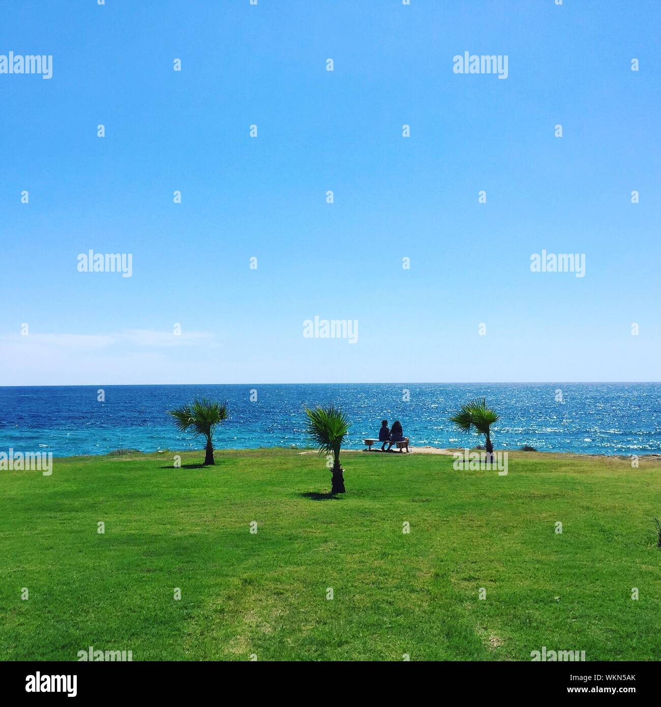 Women sitting at beach hi-res stock photography and images - Alamy