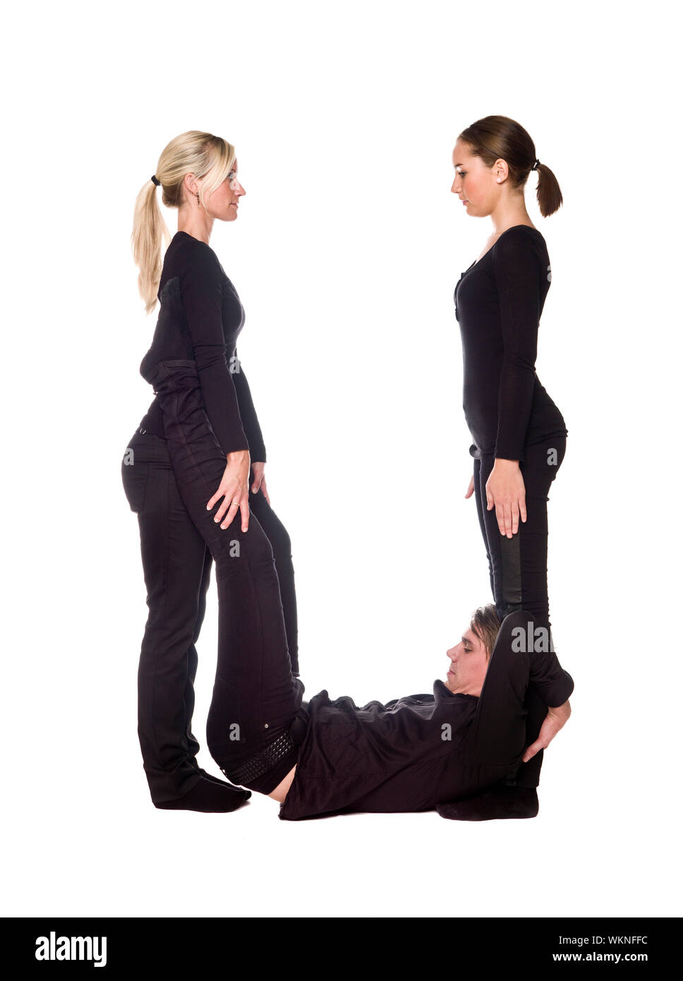 The letter 'U' formed by people dressed in black Stock Photo - Alamy