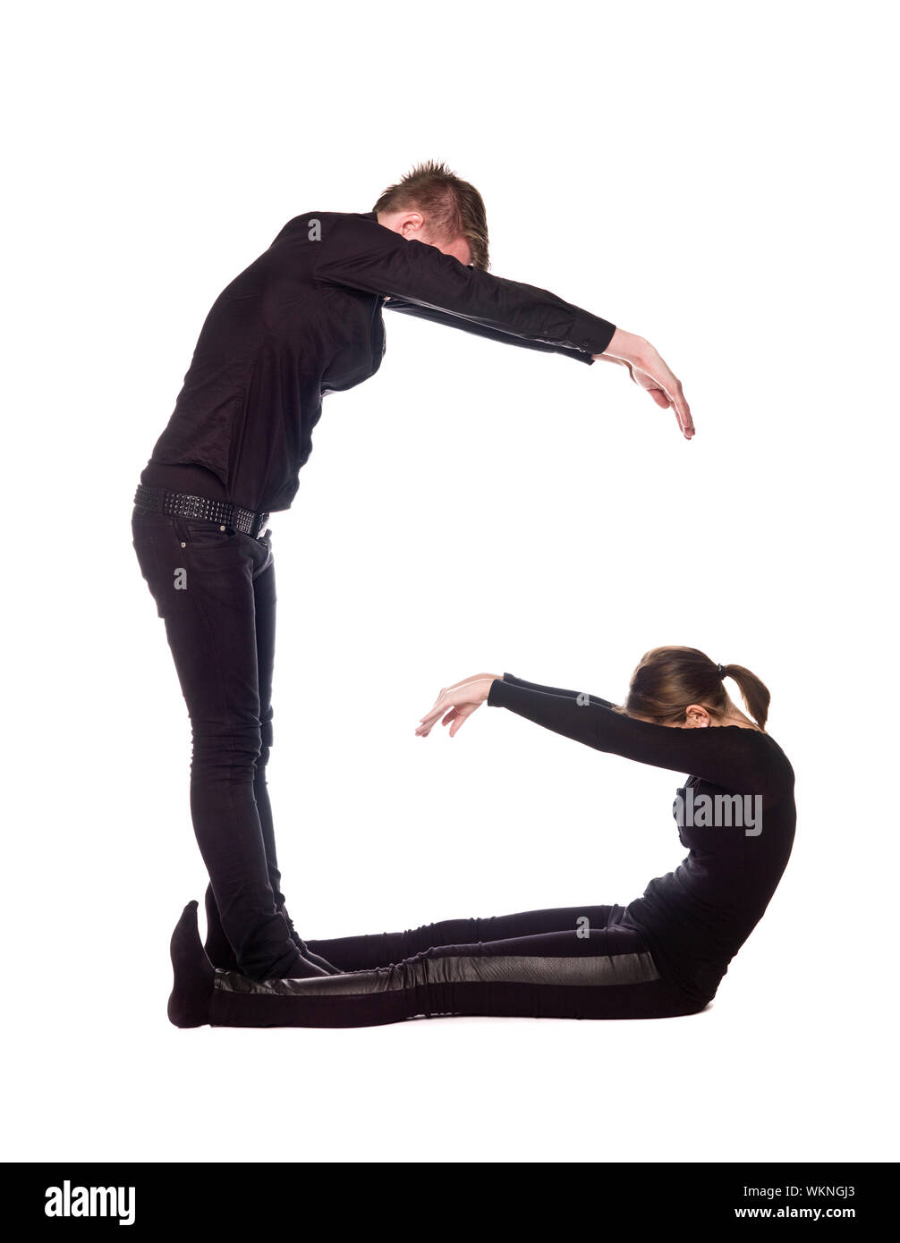 The letter 'G' formed by people dressed in black Stock Photo - Alamy