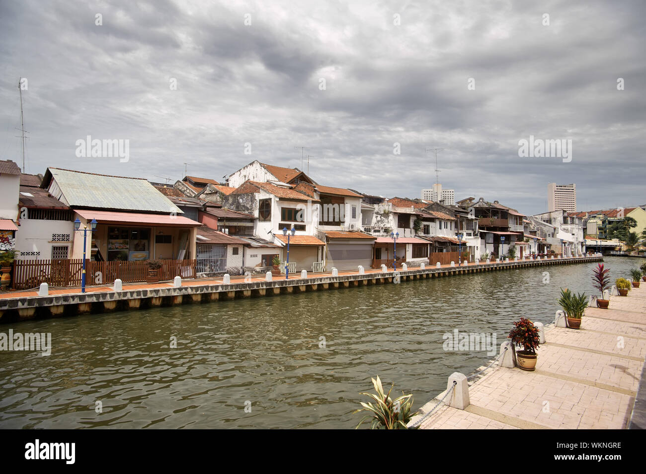 Traditional red brick and white walls of the house and sidewalk of ...