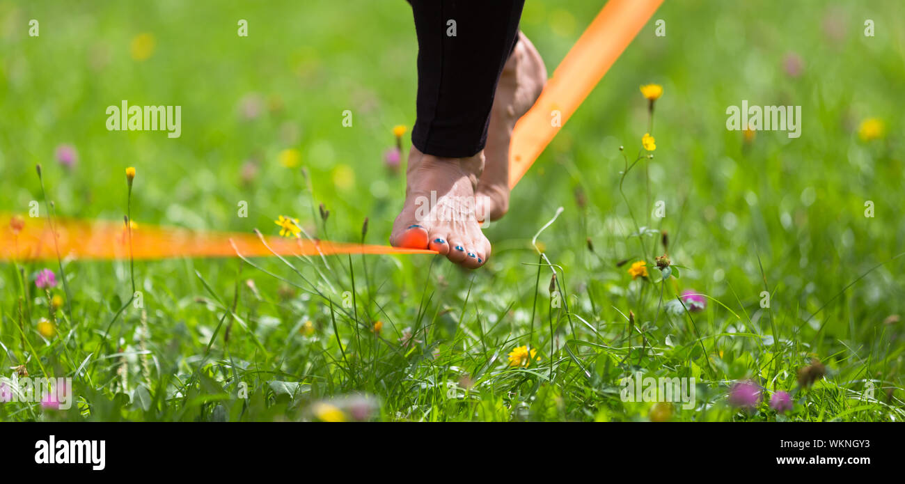 Slack line in the city park Stock Photo - Alamy