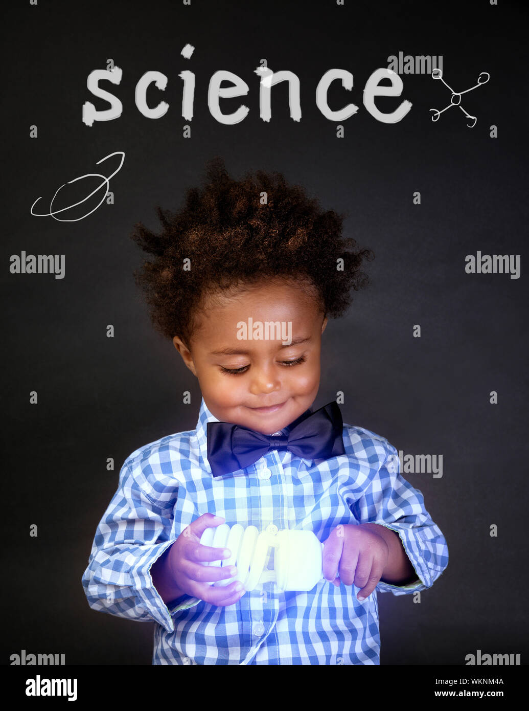 Portrait of cute clever little boy with electrical lamp in hands ...