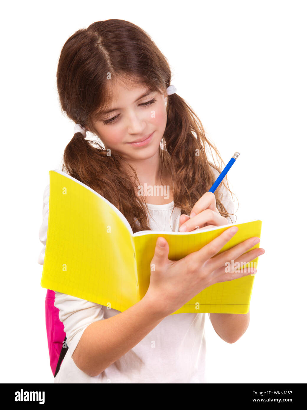 School girl writing in notebook isolated on white background, passing ...