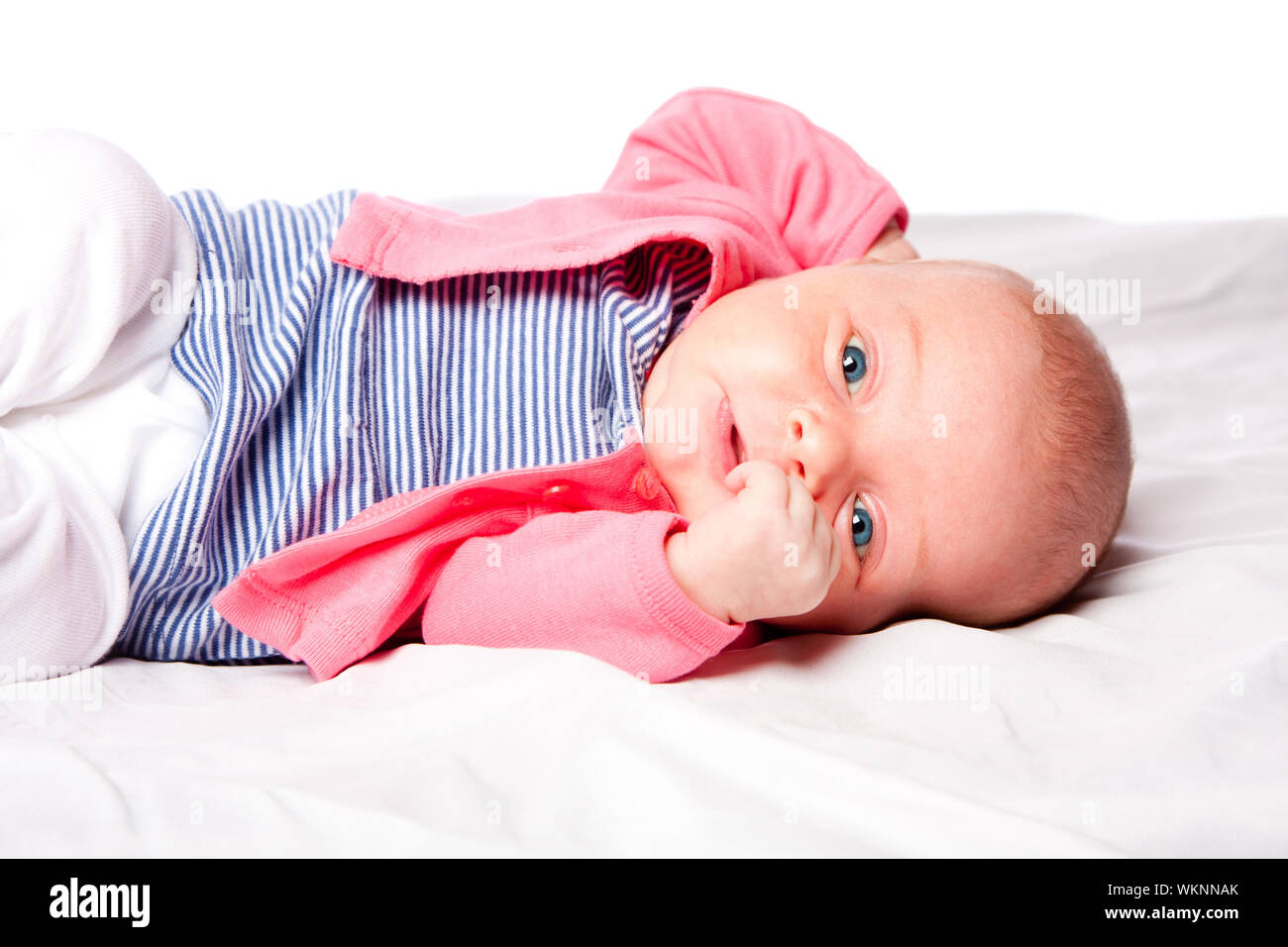 Cute baby girl with blue eyes laying in soft crib Stock Photo - Alamy
