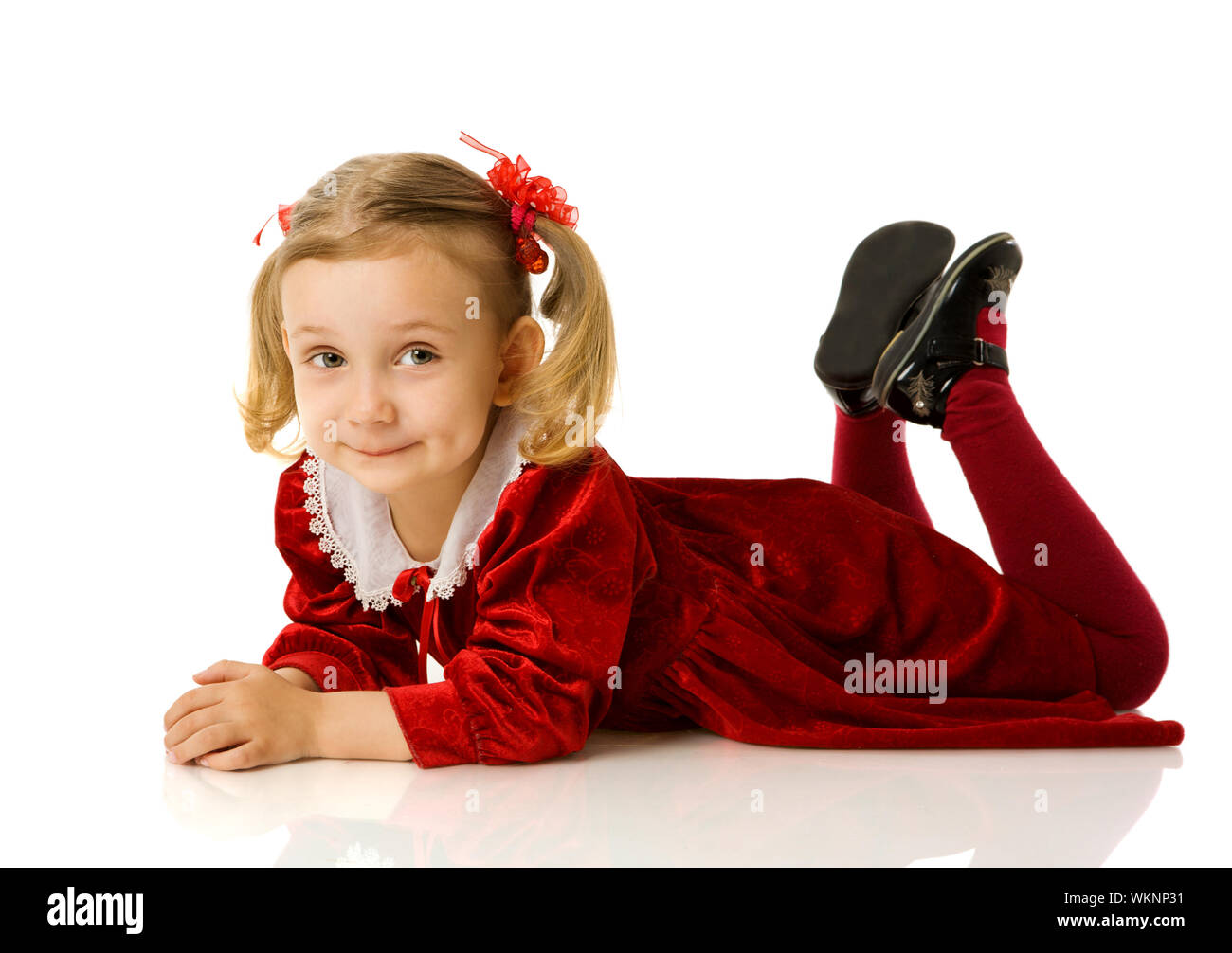 Little girl wearing beautiful dress lying down isolated on white Stock ...